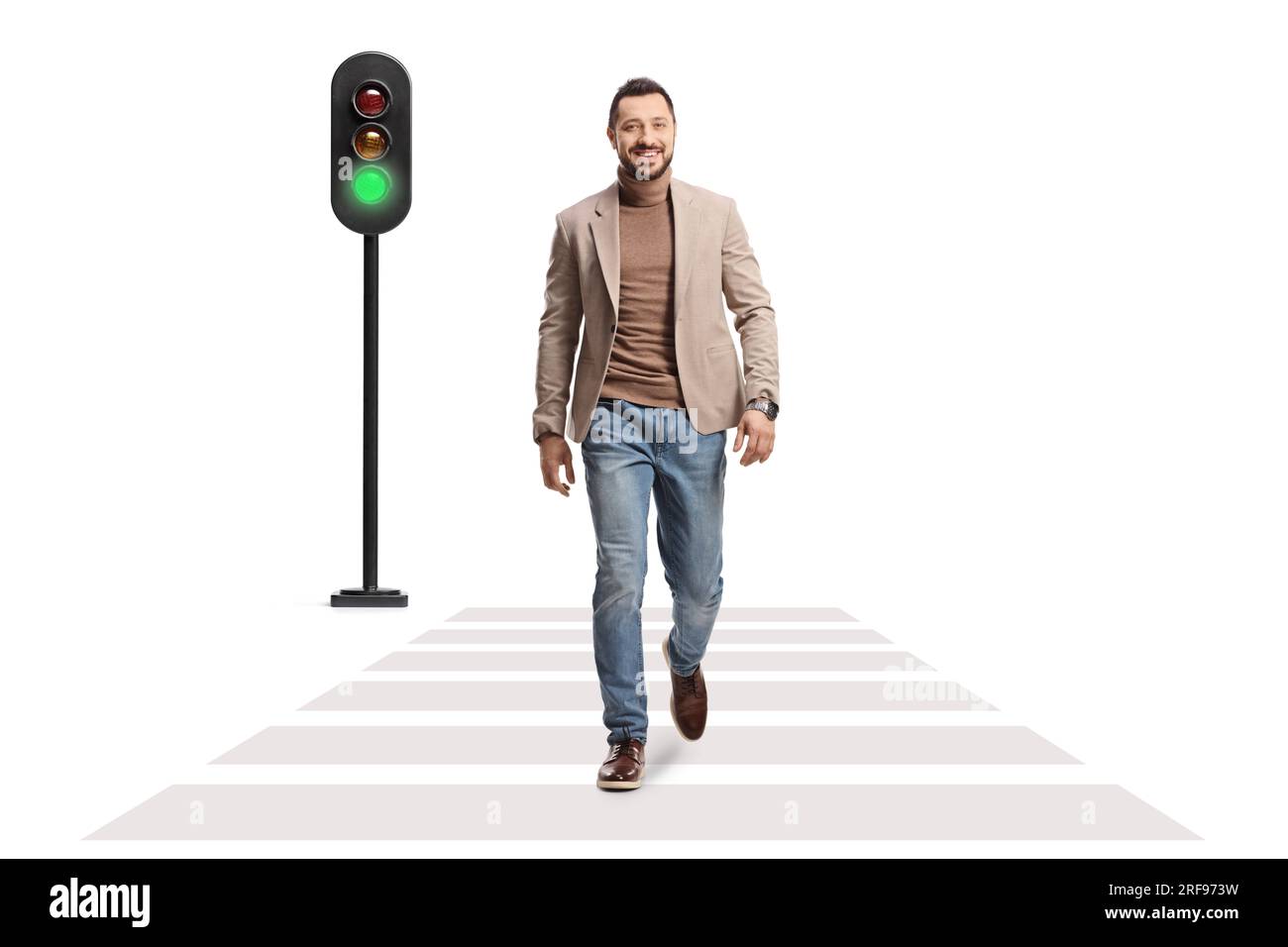 Full length portrait of a smiling man on the street walking at green ...
