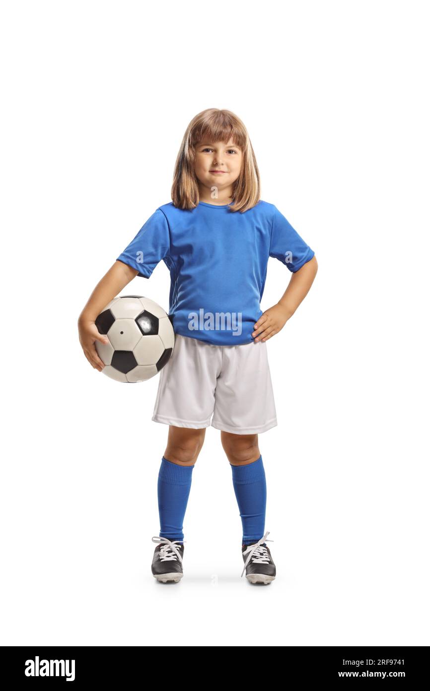 GIrl in football clothes posing with ball under arm isolated on white ...