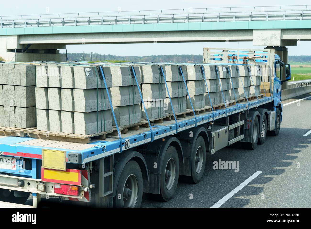 Truck on the highway transports concrete products - curbs. Import ...