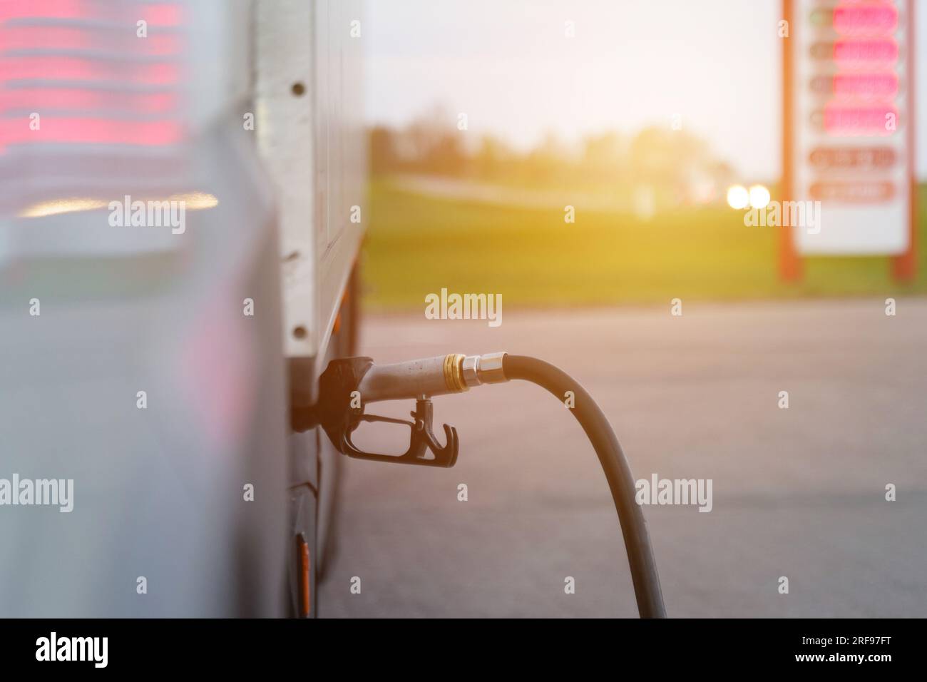 Refueling a truck. A close-up of a gas station gun inserted into the ...