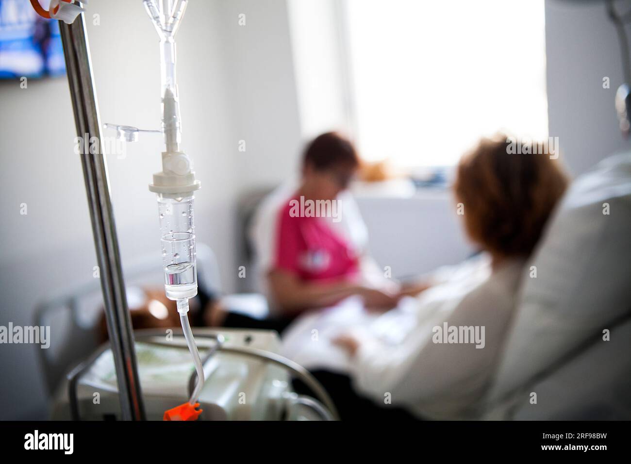 Socio-esthetician giving a cosmetic treatment to a patient during her ...