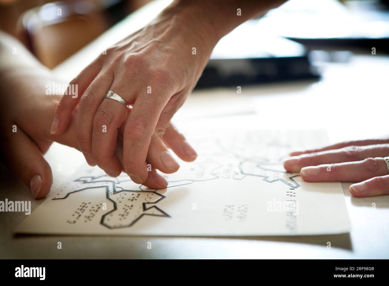 A blind or visually impaired pupil revises the maps in relief to pass ...