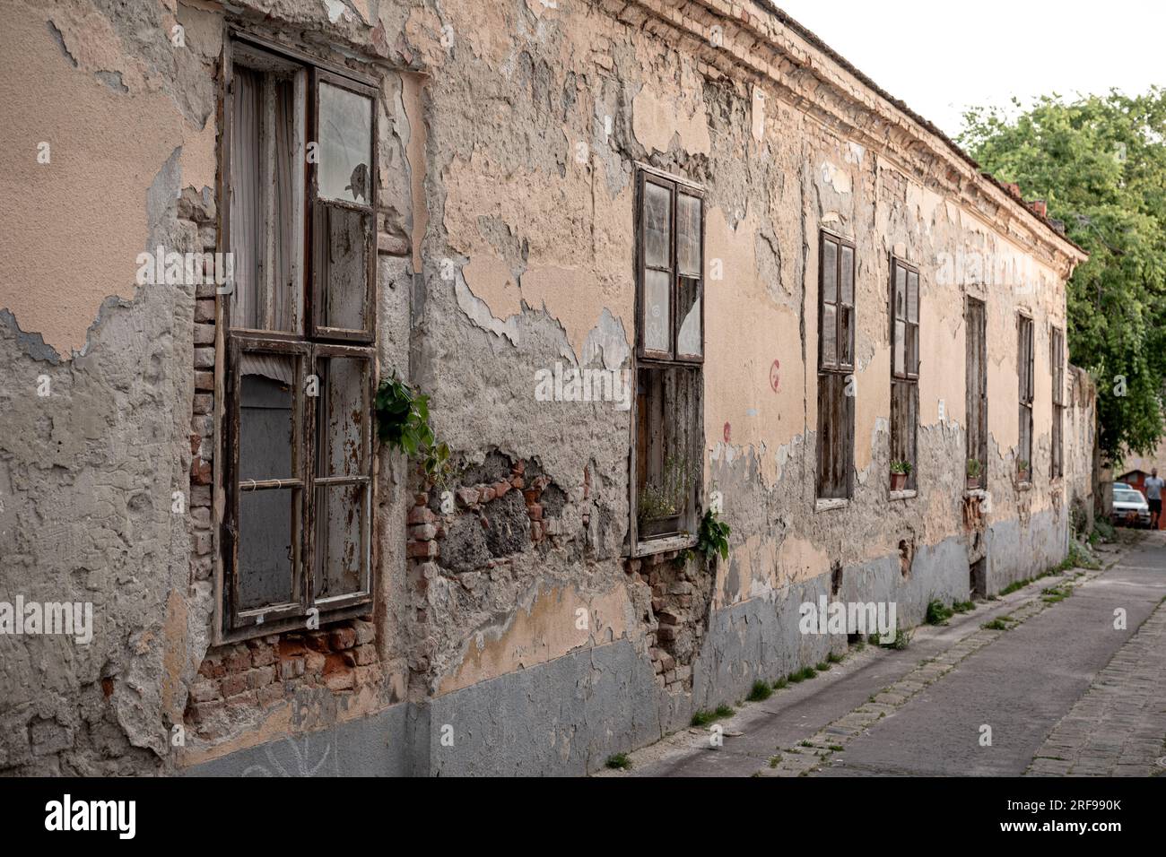 Exterior of aged abandoned building with crumbling stone walls and ...