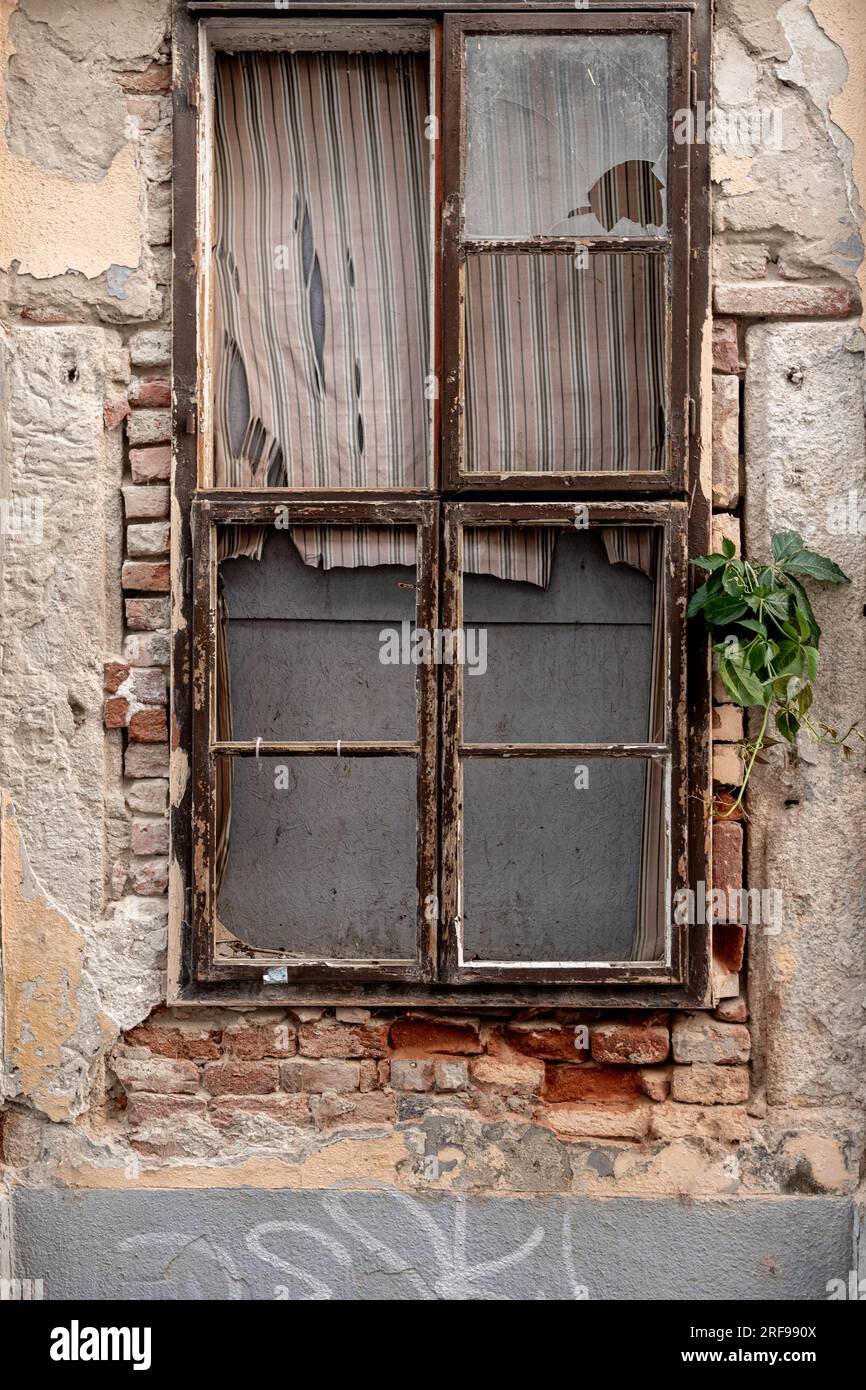 Exterior of aged abandoned building with crumbling stone walls and ...