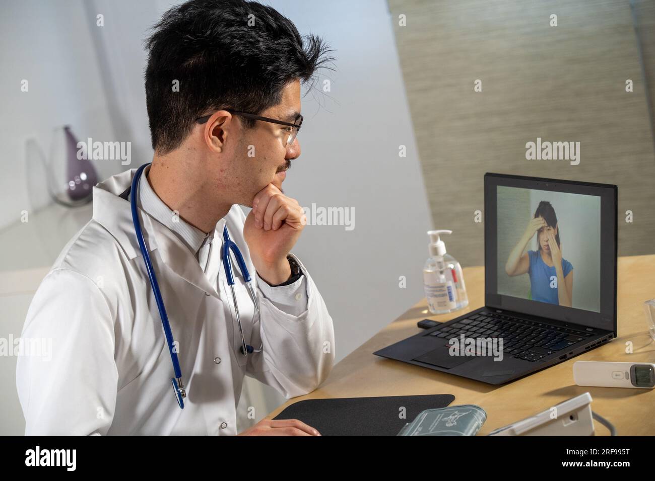 Doctor in remote consultation with 30 year old female patient with sinus pain Stock Photo - Alamy