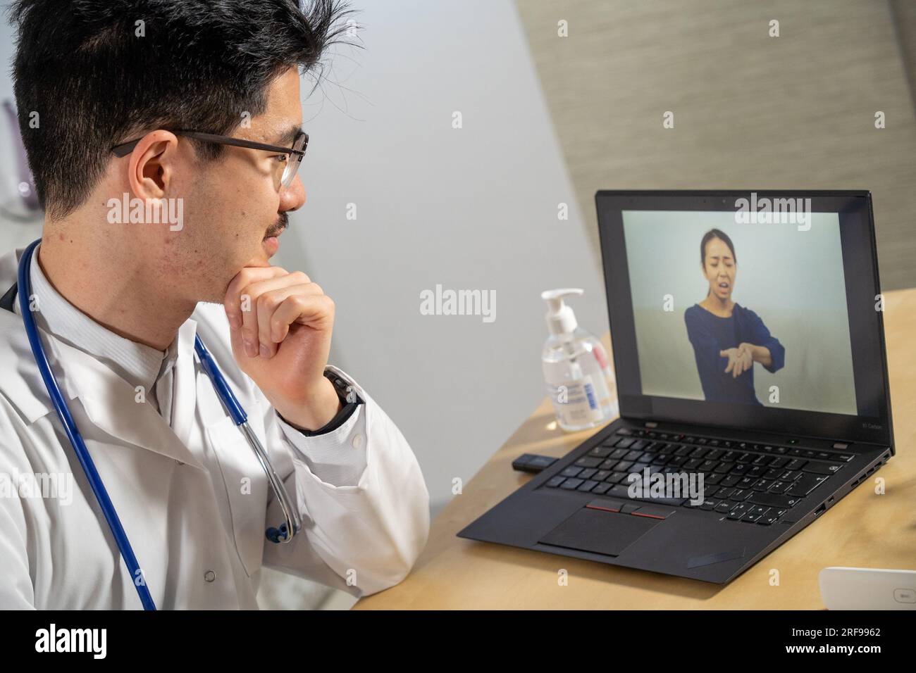 Doctor in remote consultation with 30 year old female patient with pain ...