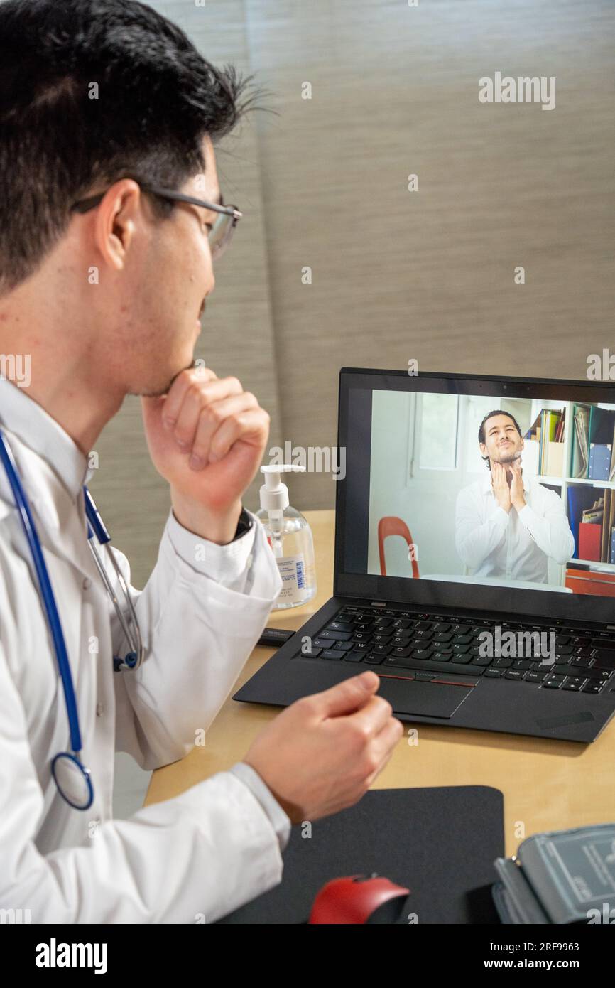 Doctor in remote consultation with 30 year old patient with pain in throat Stock Photo - Alamy