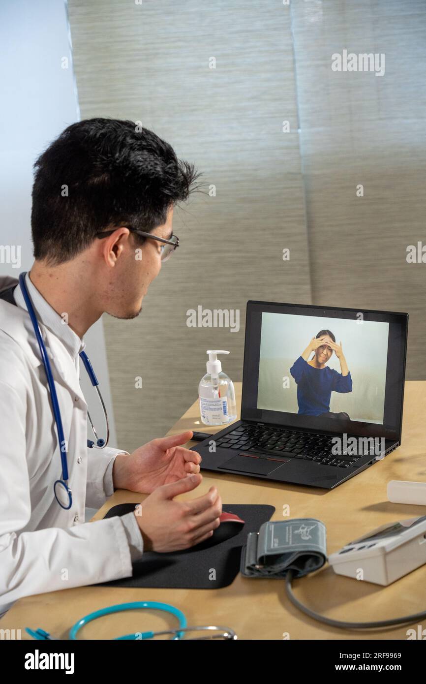 Doctor in remote consultation with 30 year old female patient with ...