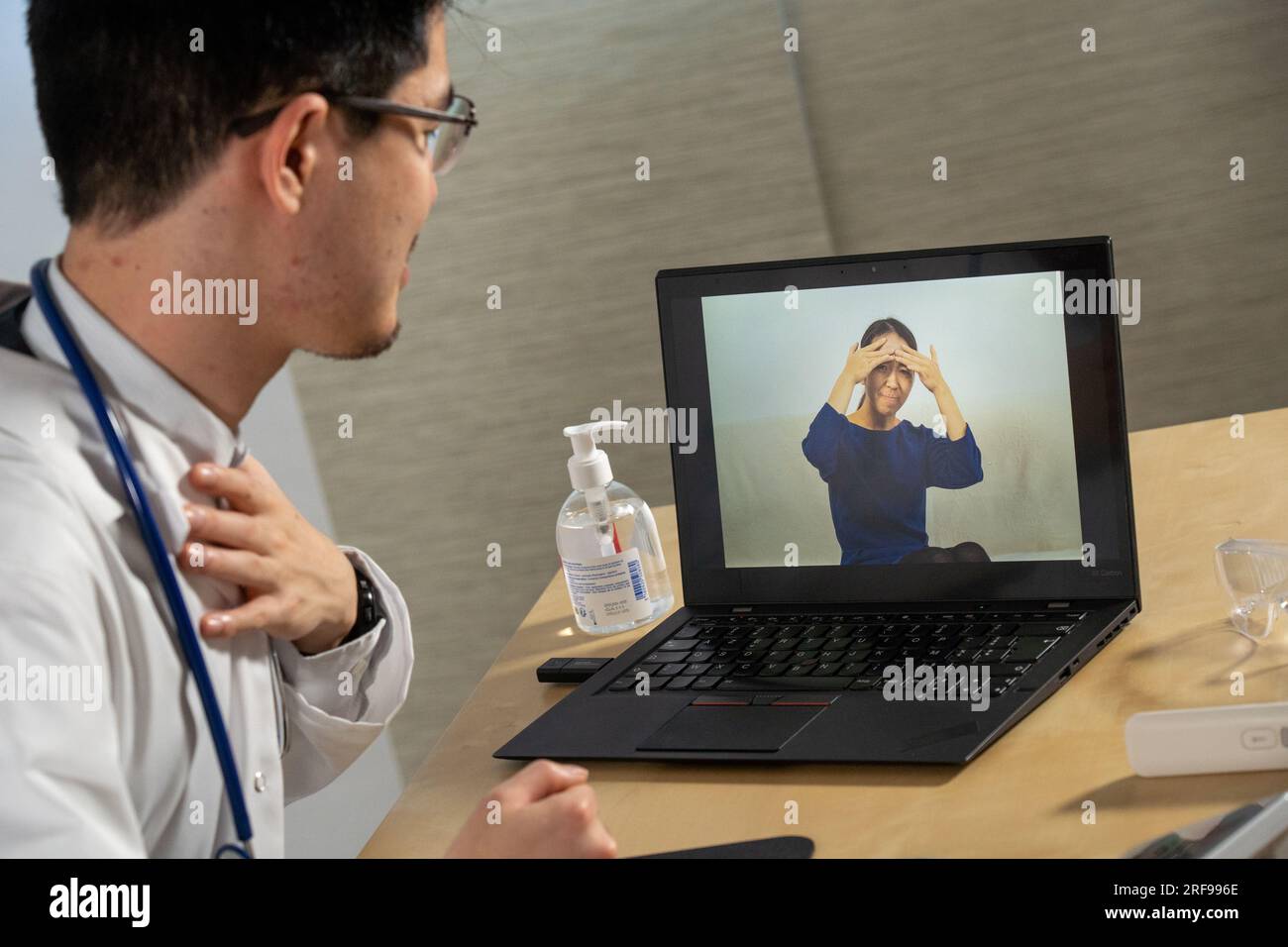 Doctor in remote consultation with 30 year old female patient with sinus pain Stock Photo - Alamy