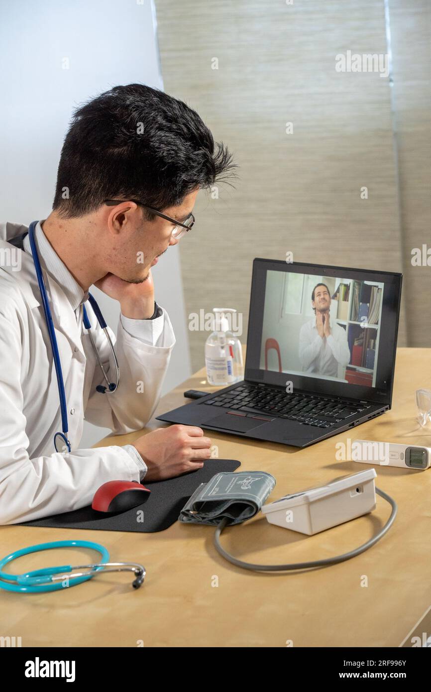 Doctor in remote consultation with 30 year old patient with pain in throat Stock Photo - Alamy