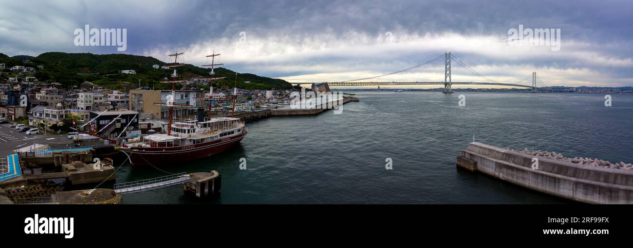 Panoramic view of historic sailing ship anchored at port by modern ...