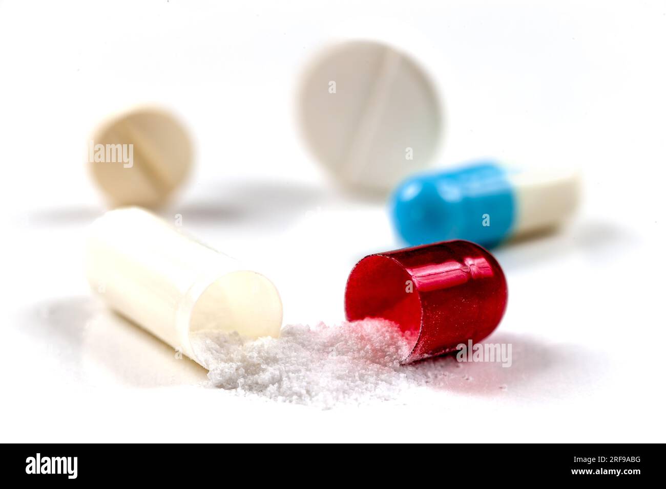 Open capsule close-up on a white background Stock Photo - Alamy