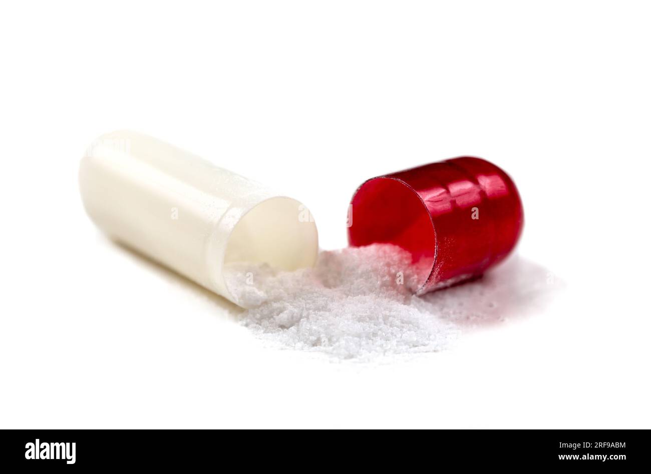 Open capsule close-up on a white background Stock Photo - Alamy