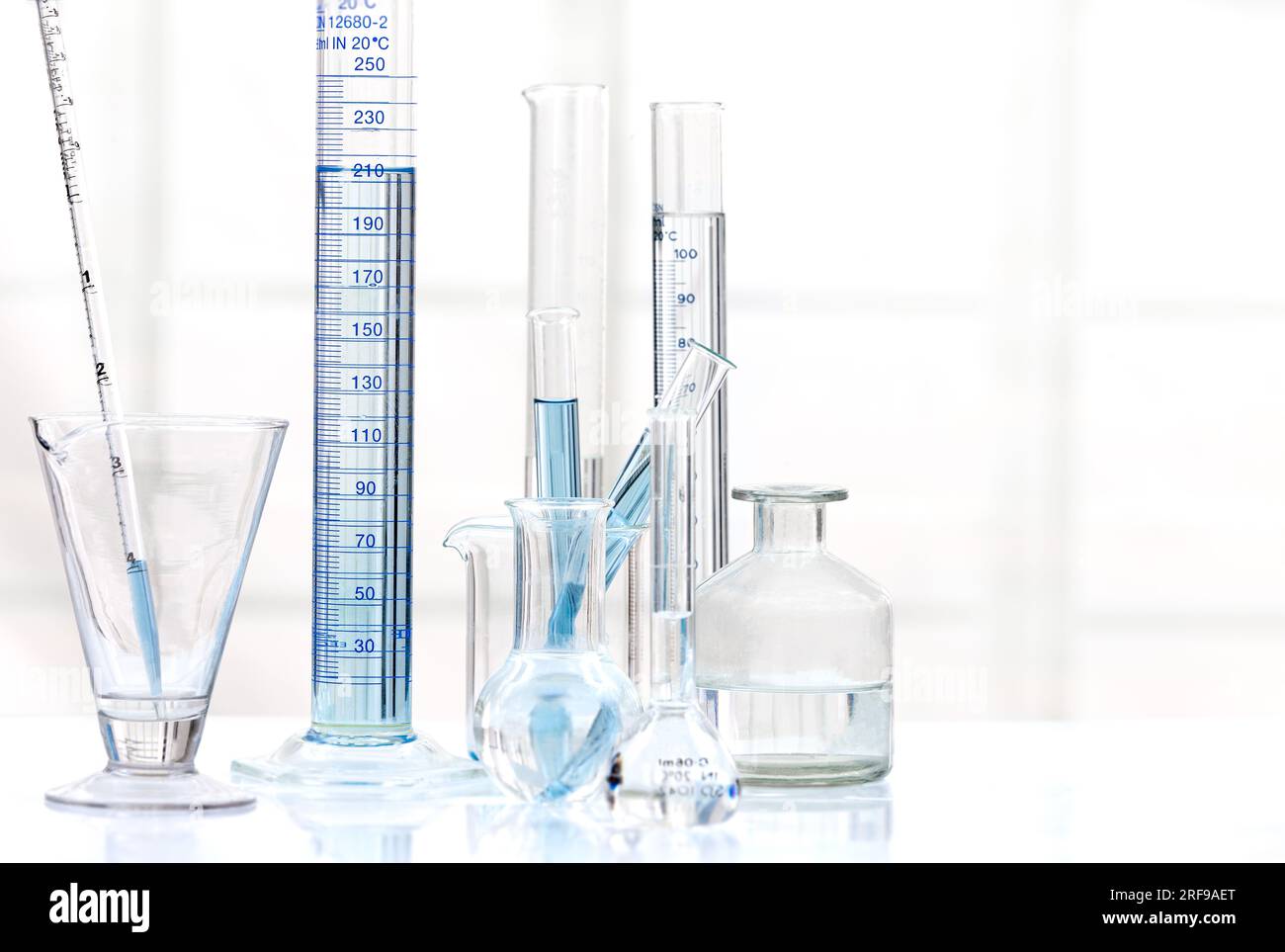 Set of laboratory glassware on plain background Stock Photo - Alamy