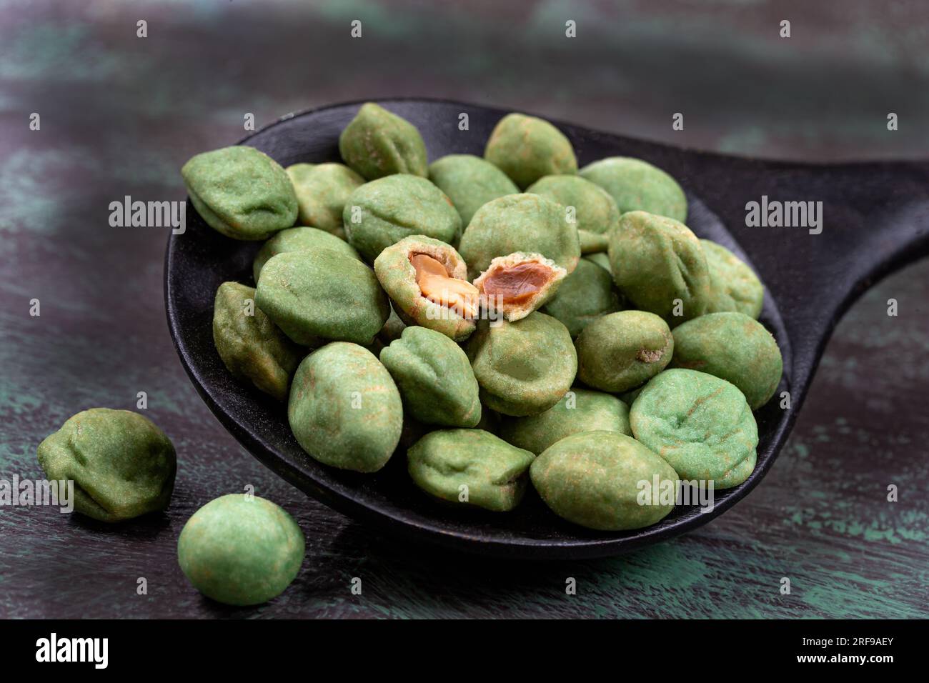 Wasabi coated peanuts close up Stock Photo - Alamy