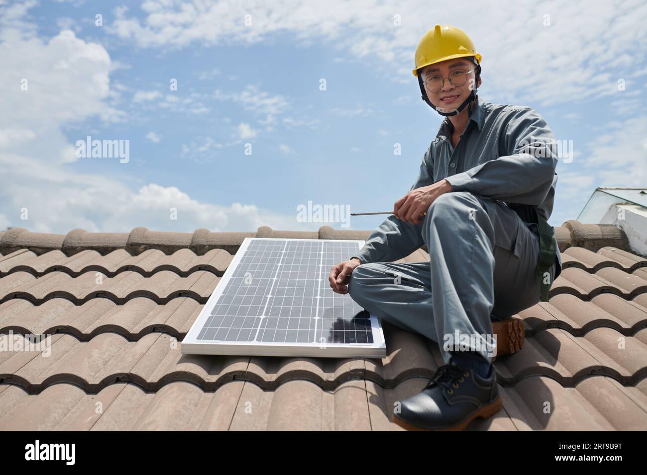 Worker solar power station smiling hi-res stock photography and images ...
