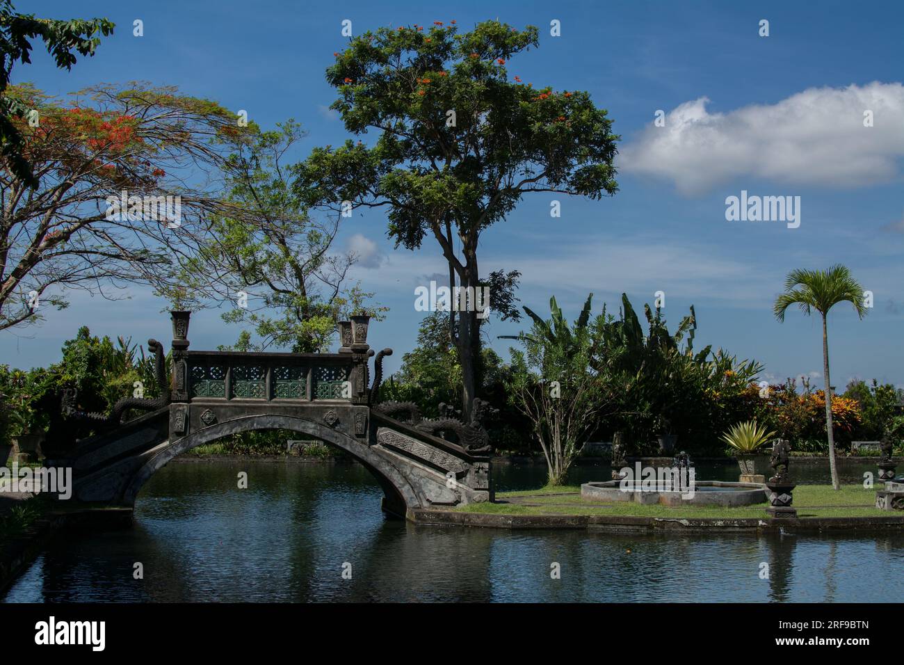 Stone Balinese Statues On Water In The Lake Water Palace Tirta Gangga ...