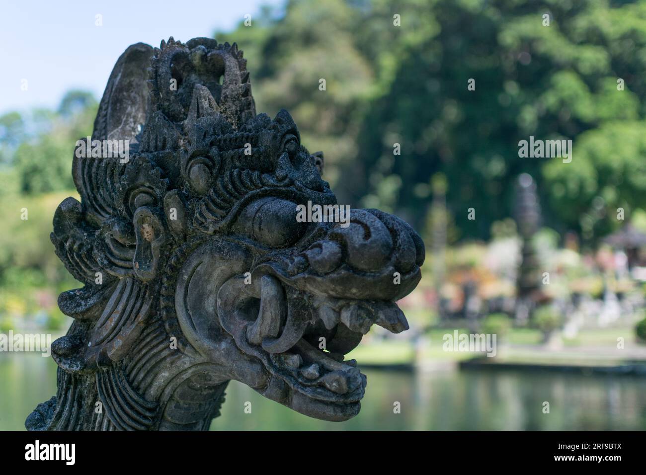 Stone Balinese Statues On Water In The Lake Water Palace Tirta Gangga ...