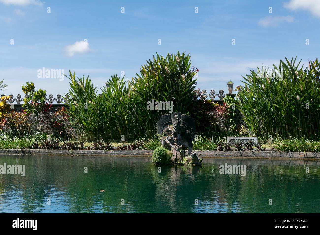 Stone Balinese Statues On Water In The Lake Water Palace Tirta Gangga ...