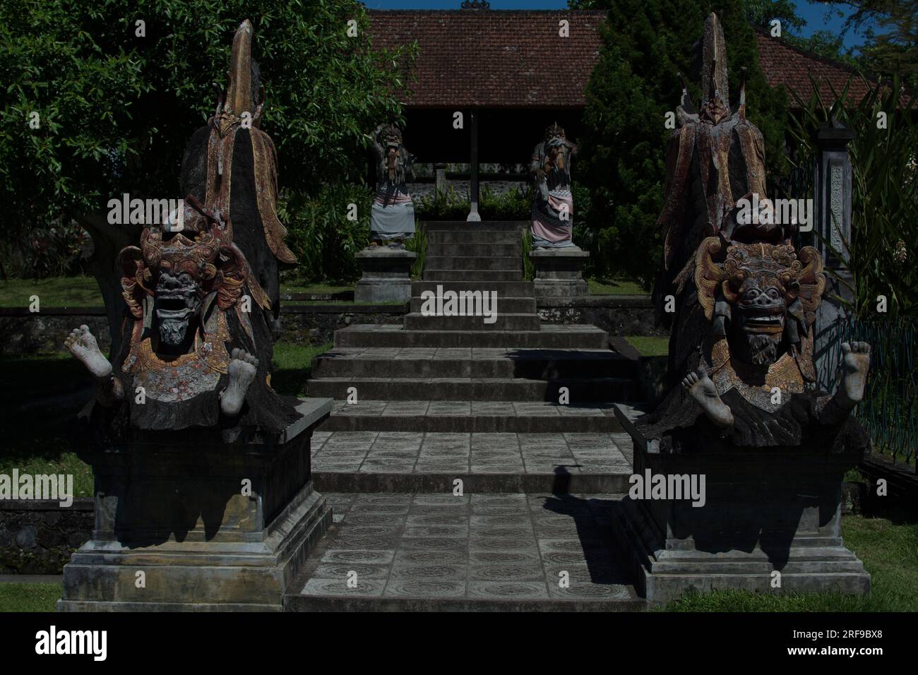 Stone Balinese Statues On Water In The Lake Water Palace Tirta Gangga ...