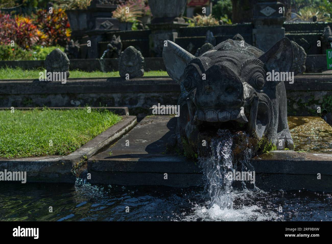 Stone Balinese Statues On Water In The Lake Water Palace Tirta Gangga ...