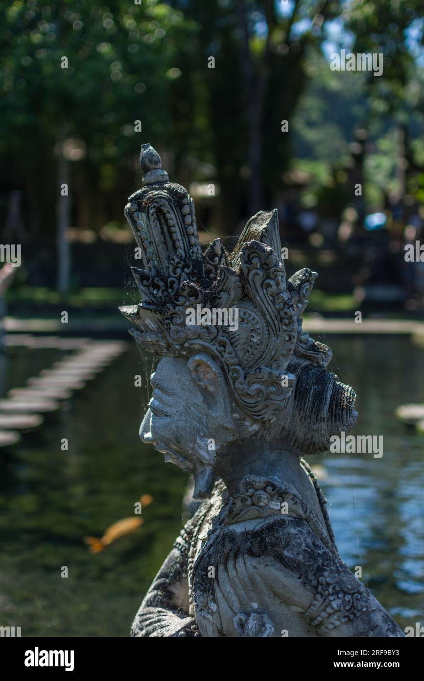 Stone Balinese Statues On Water In The Lake Water Palace Tirta Gangga ...