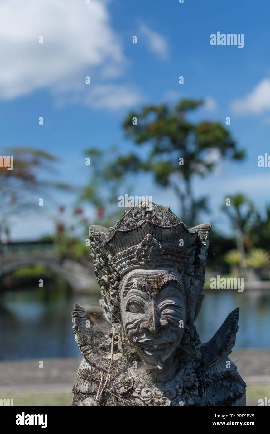 Stone Balinese Statues On Water In The Lake Water Palace Tirta Gangga ...