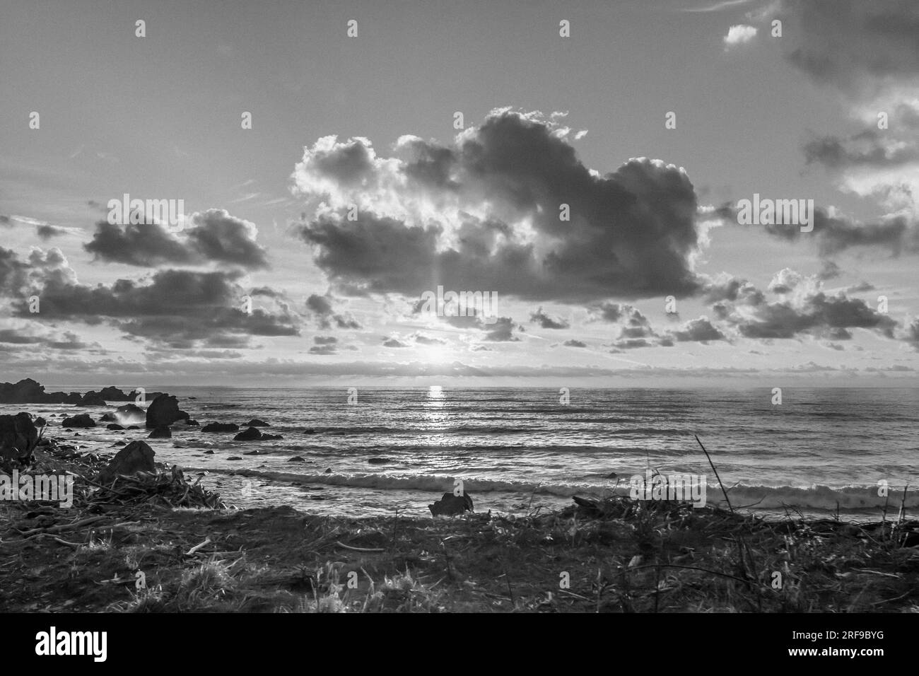 Sunset on remote beach Black and White Stock Photos & Images - Alamy
