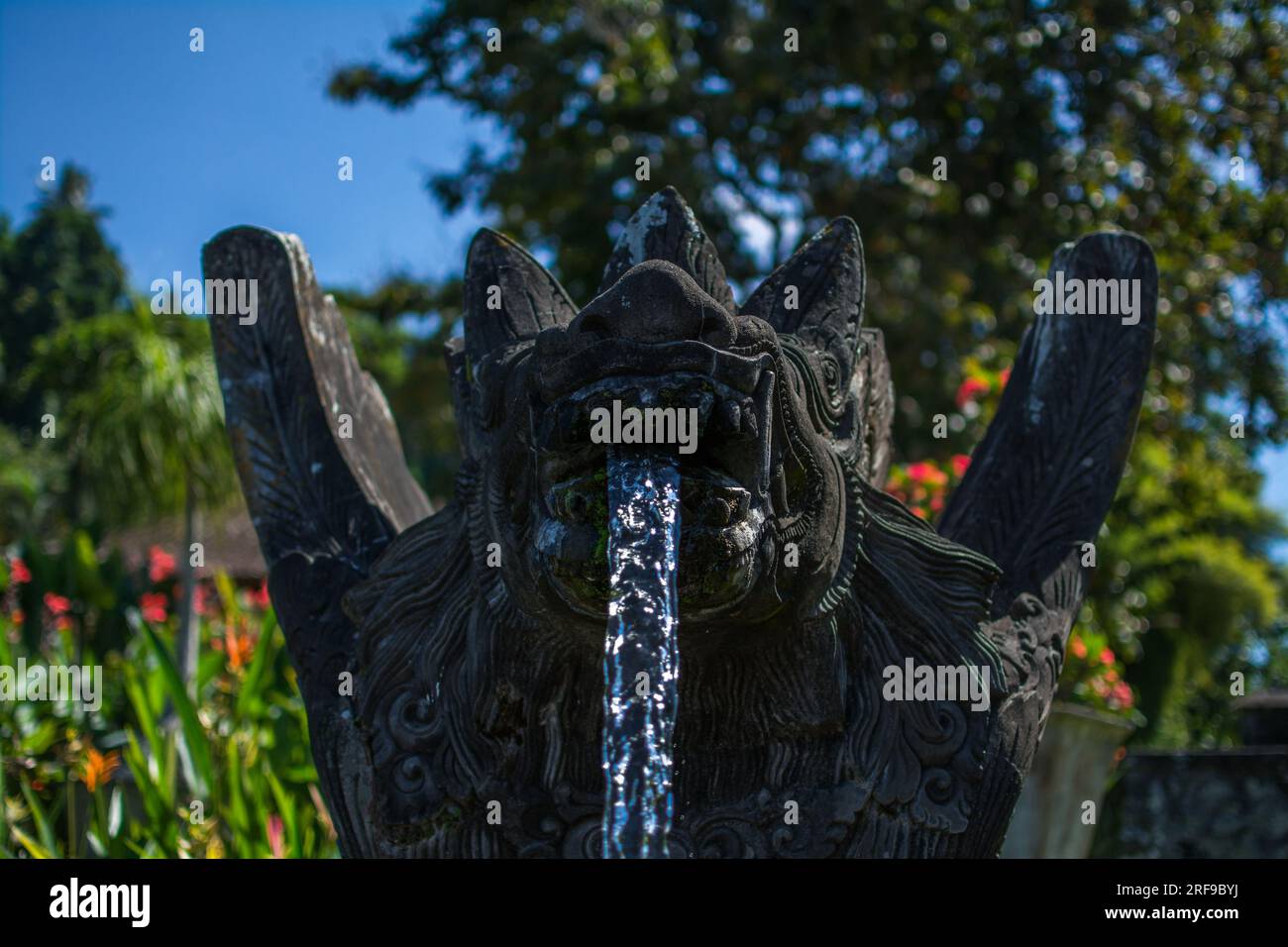 Stone Balinese Statues On Water In The Lake Water Palace Tirta Gangga ...