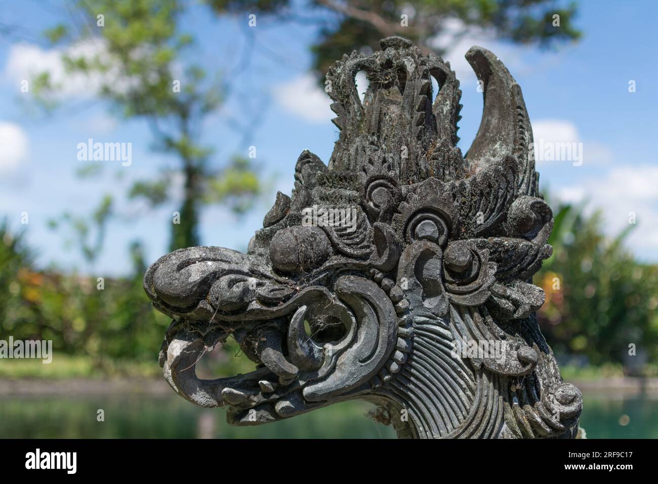 Stone Balinese Statues On Water In The Lake Water Palace Tirta Gangga ...