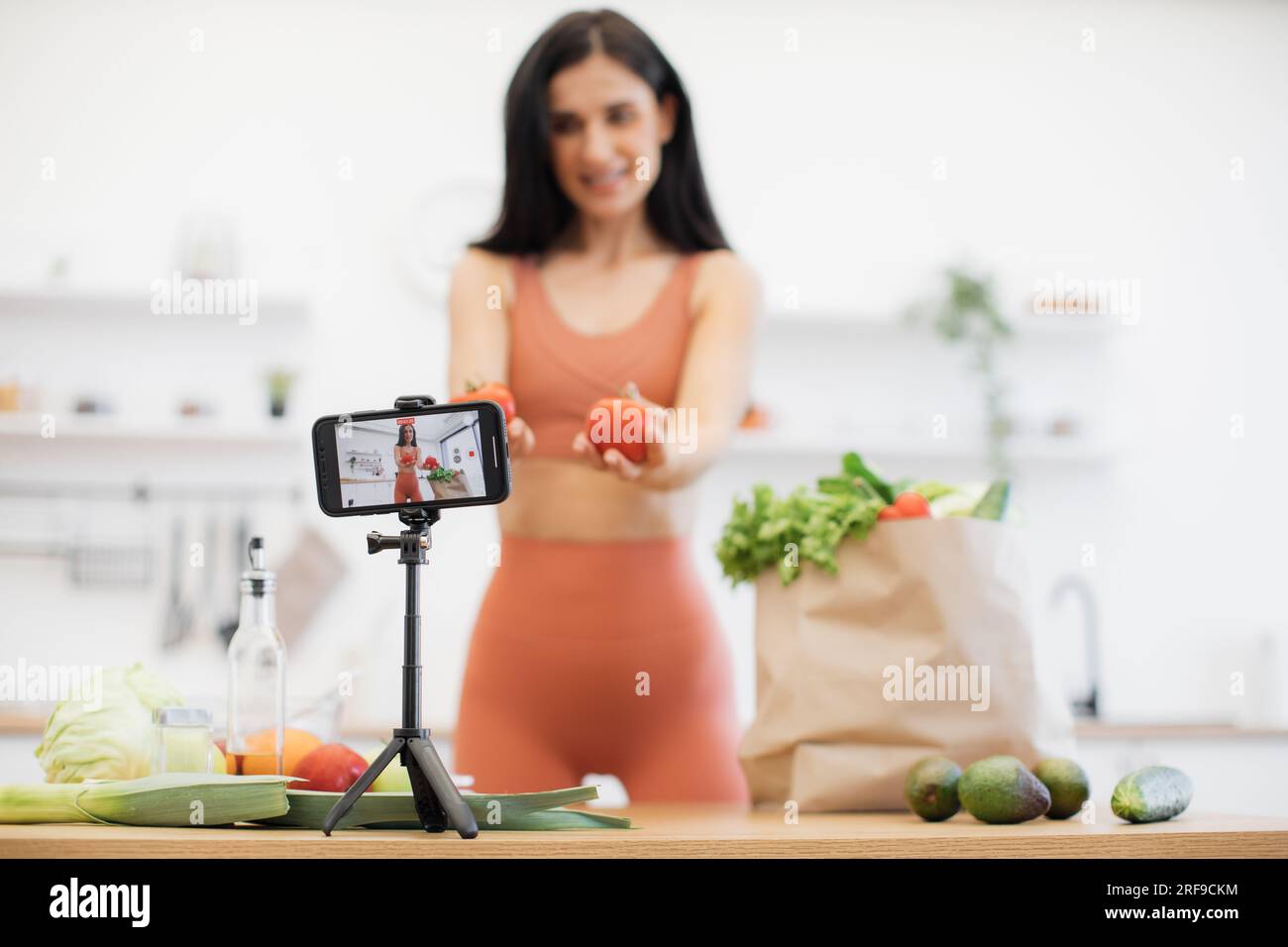 Focus on smart device with working camera app fixed by tripod on ...