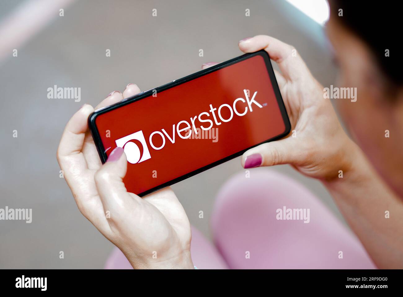 In this photo illustration, the Overstock logo is seen displayed on a ...