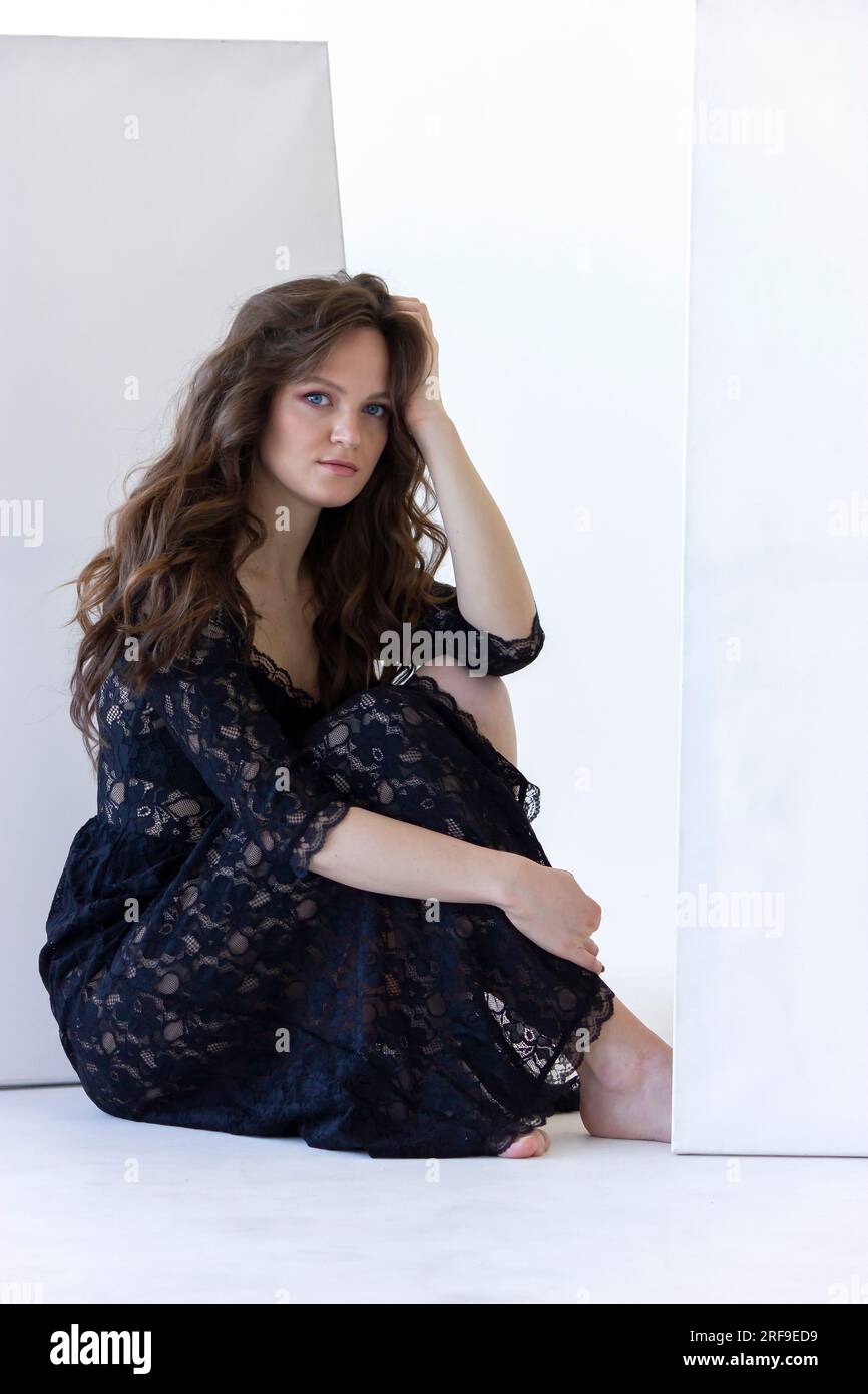 Young Woman Stands Between White Blank Large Stretched Canvases for ...