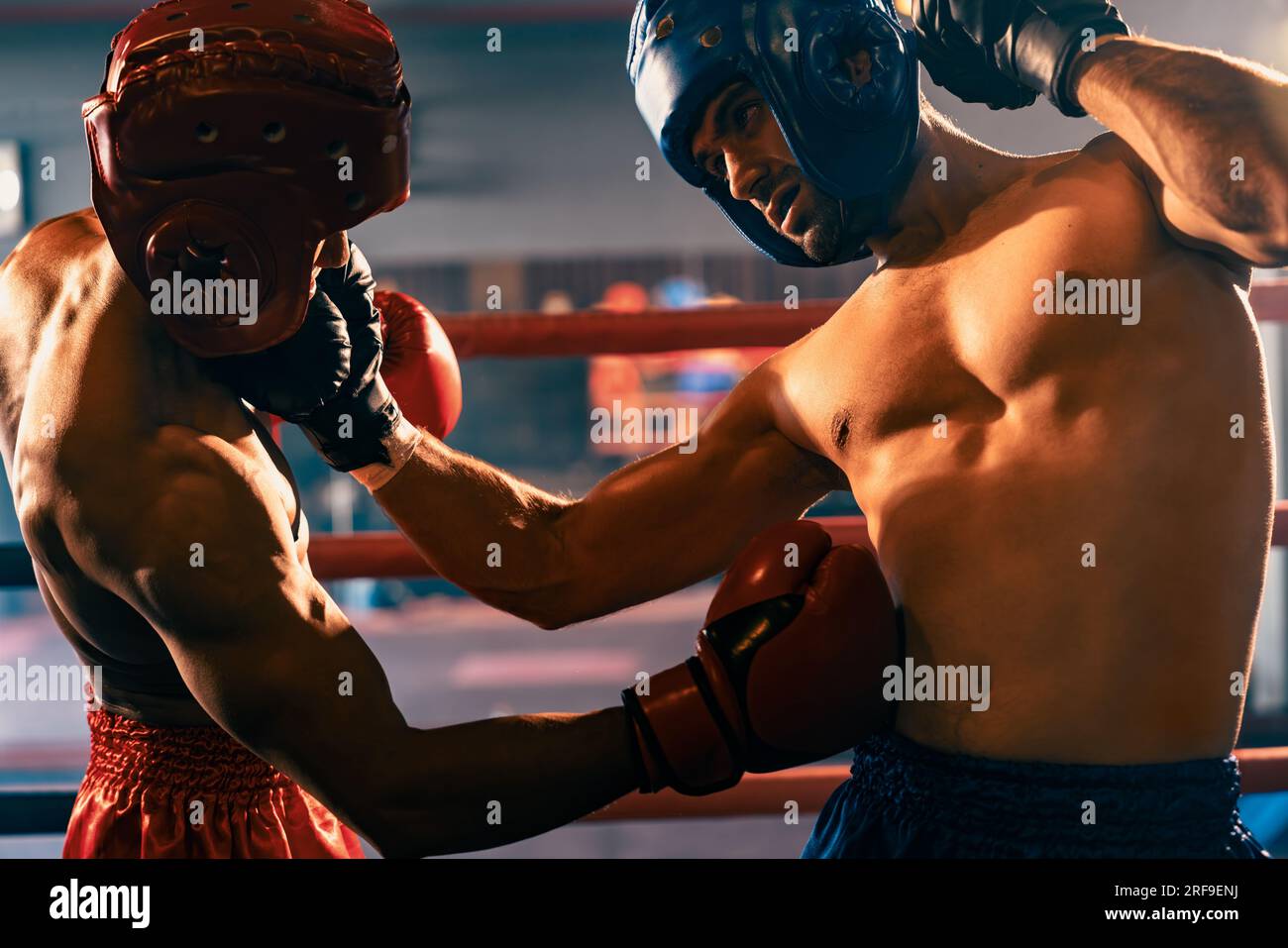 Two athletic and muscular body boxers with safety helmet or boxing head ...