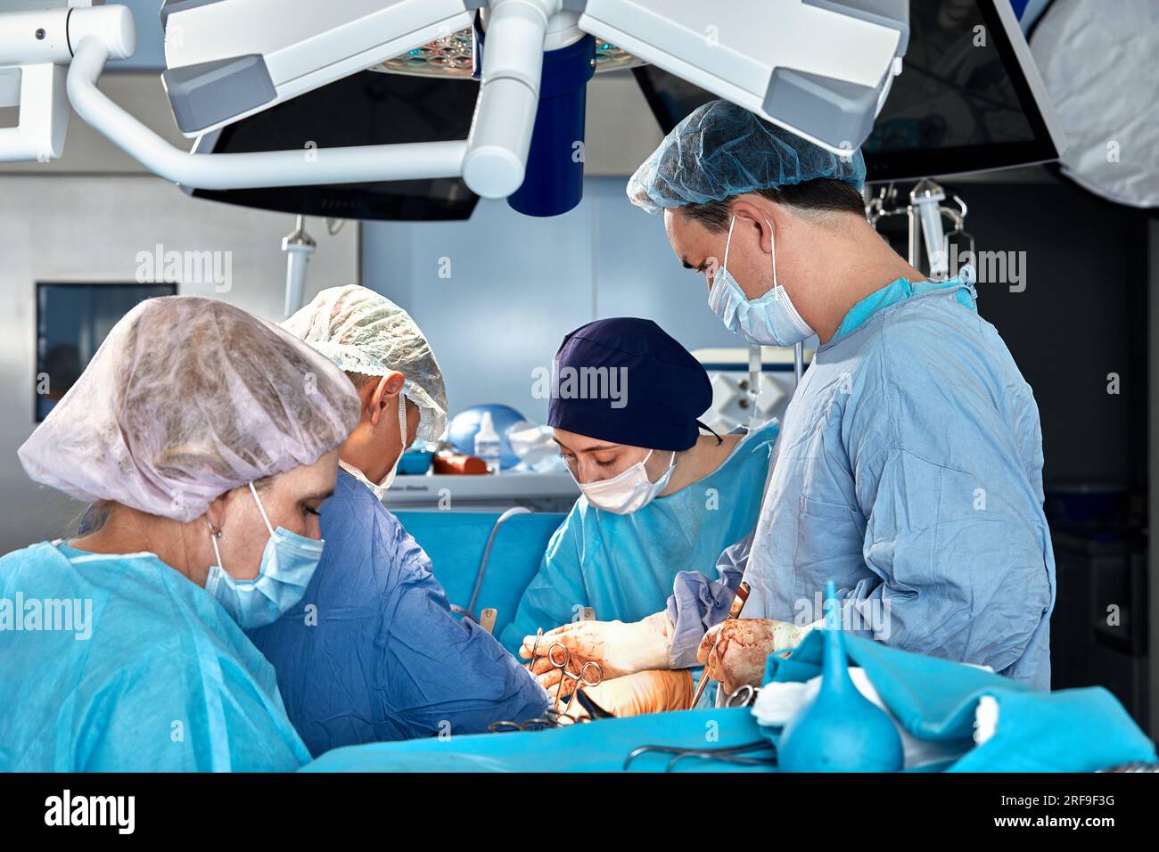 Surgeons team during complex surgical operation in a sterile operating ...