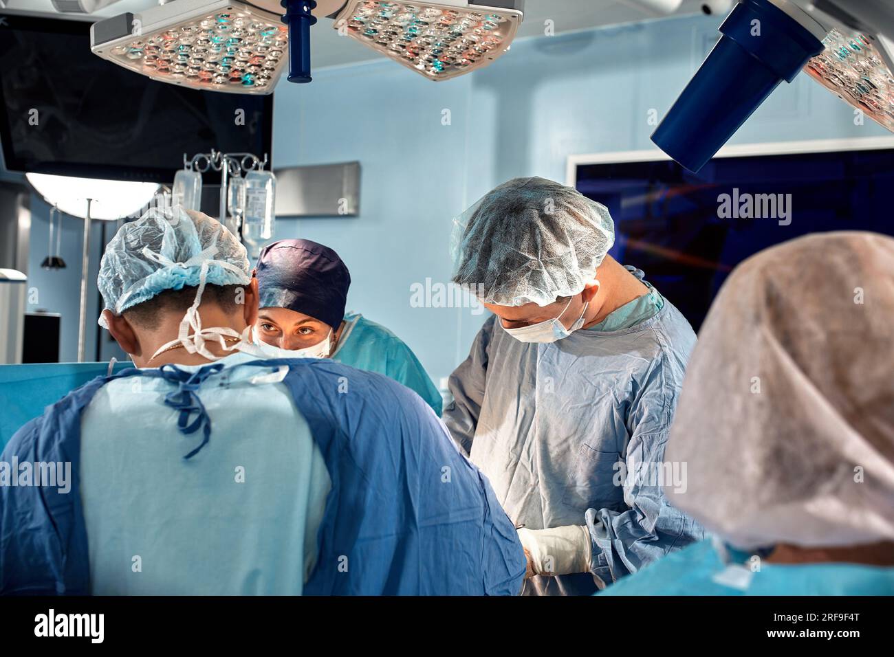 Surgeons team during complex surgical operation in a sterile operating ...