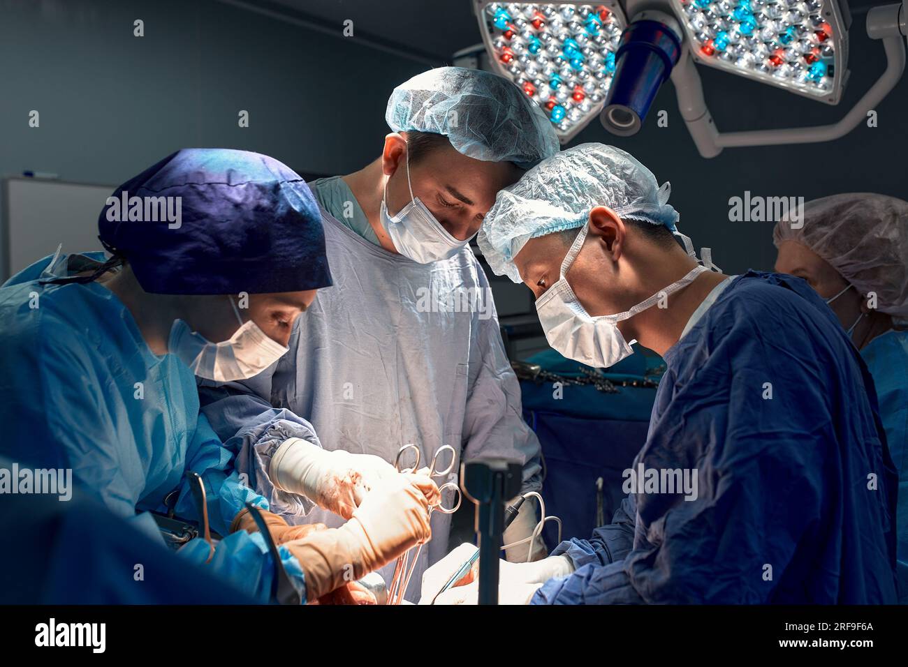 Surgeons team during complex surgical operation in a sterile operating ...