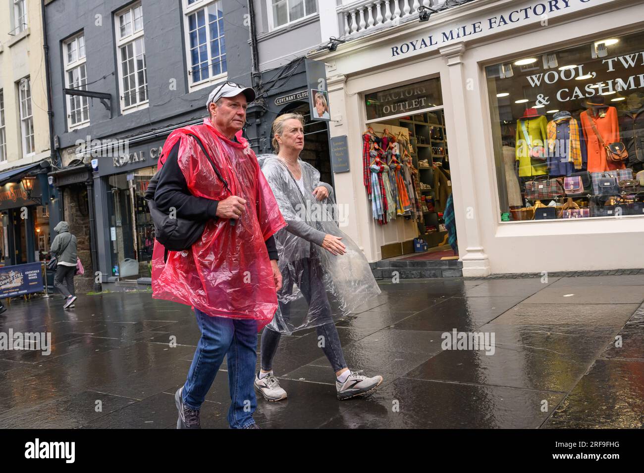Tourists In Ponchos Walking On A Rainy Day On High Street, The Royal ...