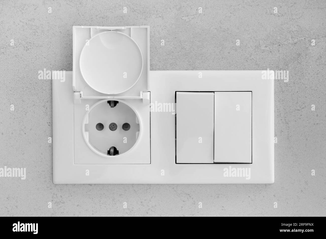 Closed socket and switch on porcelain stoneware in the bathroom Stock ...