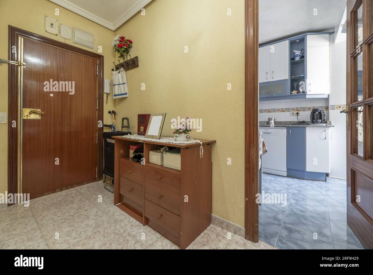 Entrance hall of a residential house with walls painted yellow with ...