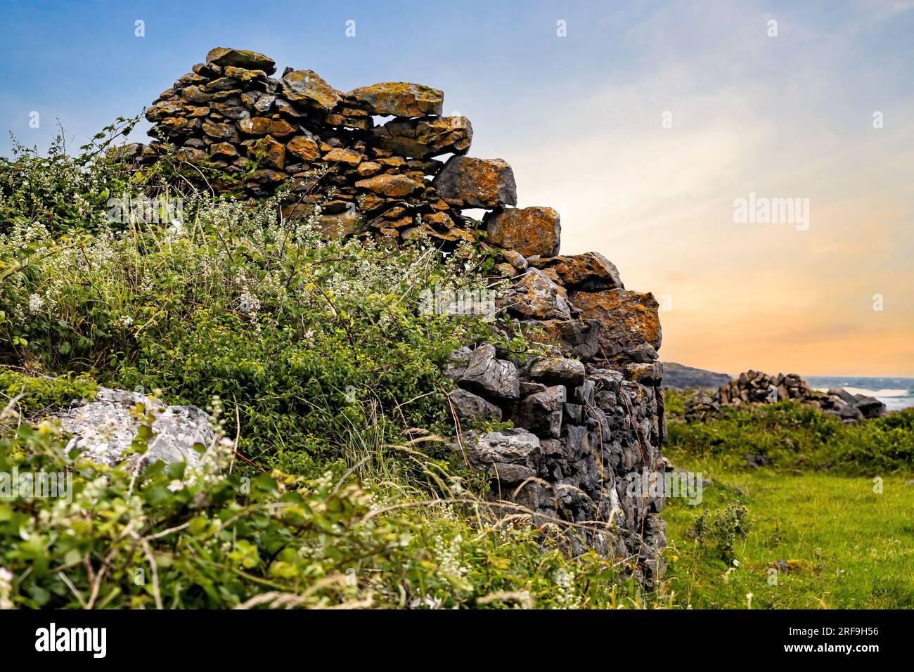 Old Irish celtic buildings stone ruins at coastline in summer Stock ...
