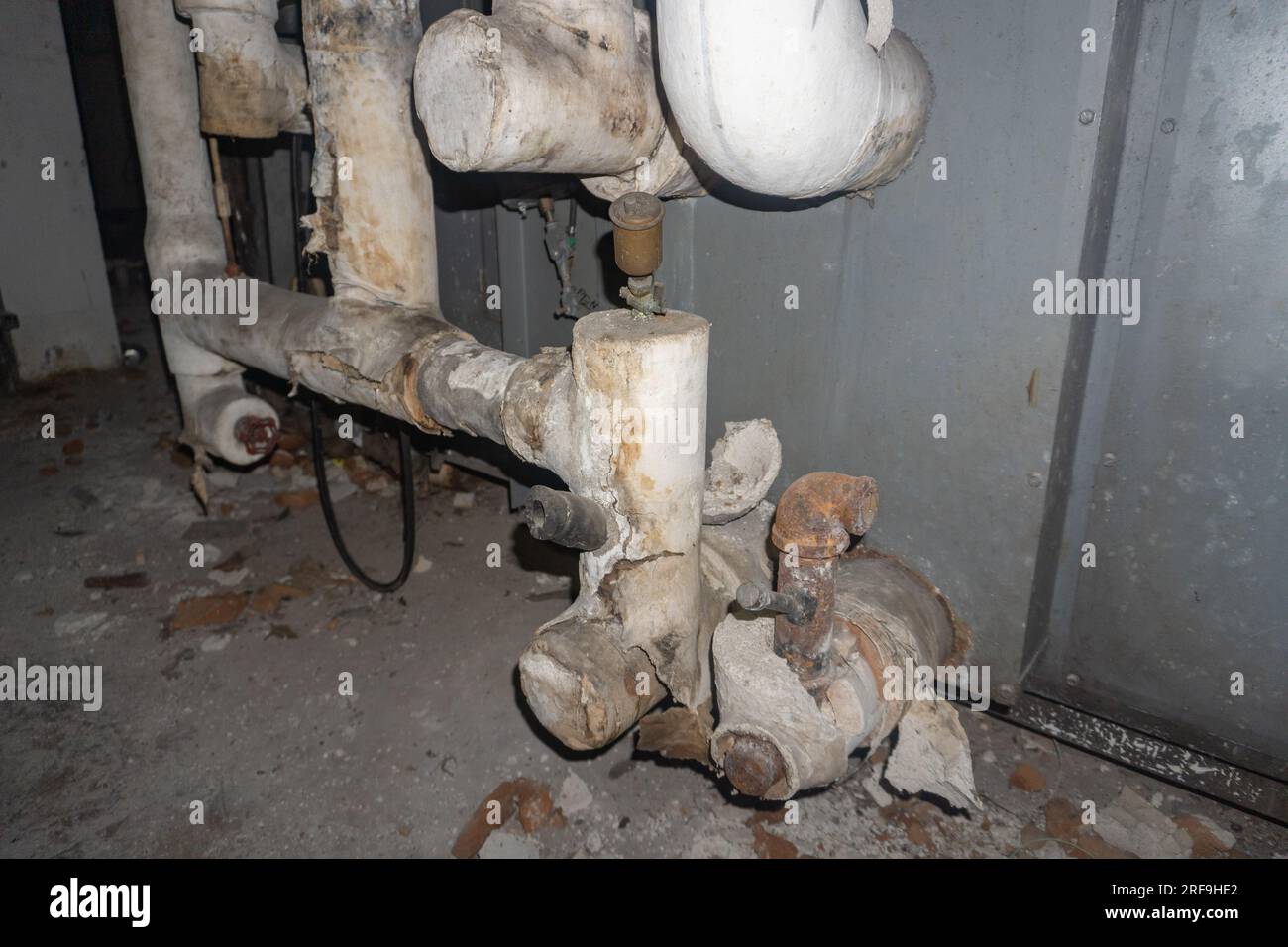 Photo of pipe insulation containing asbestos fiber in a mechanical room ...