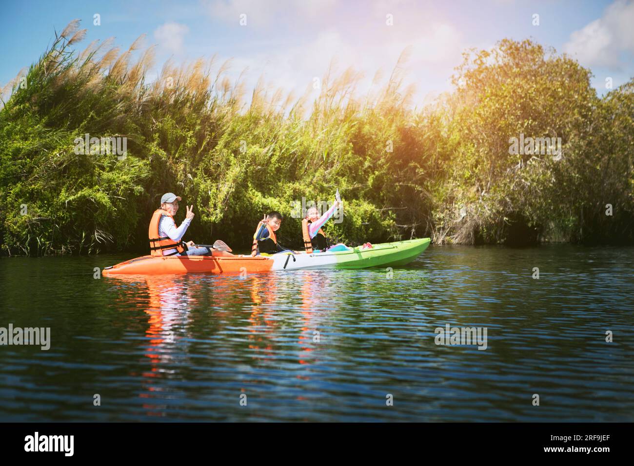 asian family sailing kayak boat in fresh water lagoon ,kayaking is one ...