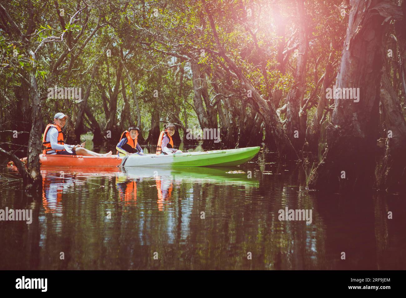 asian family sailing fresh water kayak in mangrove lagoon,kayaking is ...