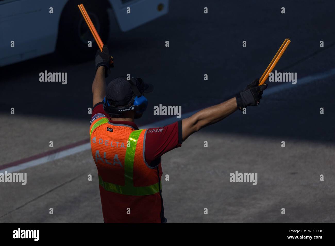 Runway signaling worker is seen at the Dallas-Fort Worth International ...