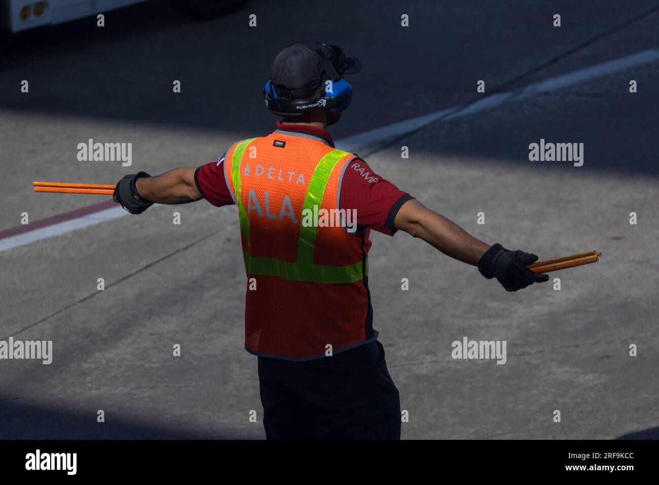 Runway signaling worker is seen at the Dallas-Fort Worth International ...