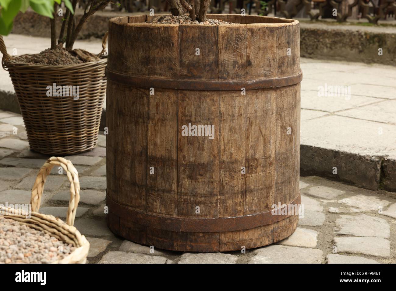 Traditional wooden barrel and wicker baskets outdoors Stock Photo - Alamy
