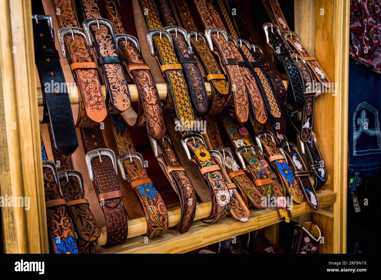 Cowboy boots and leather belts in a business showcase in the center of ...