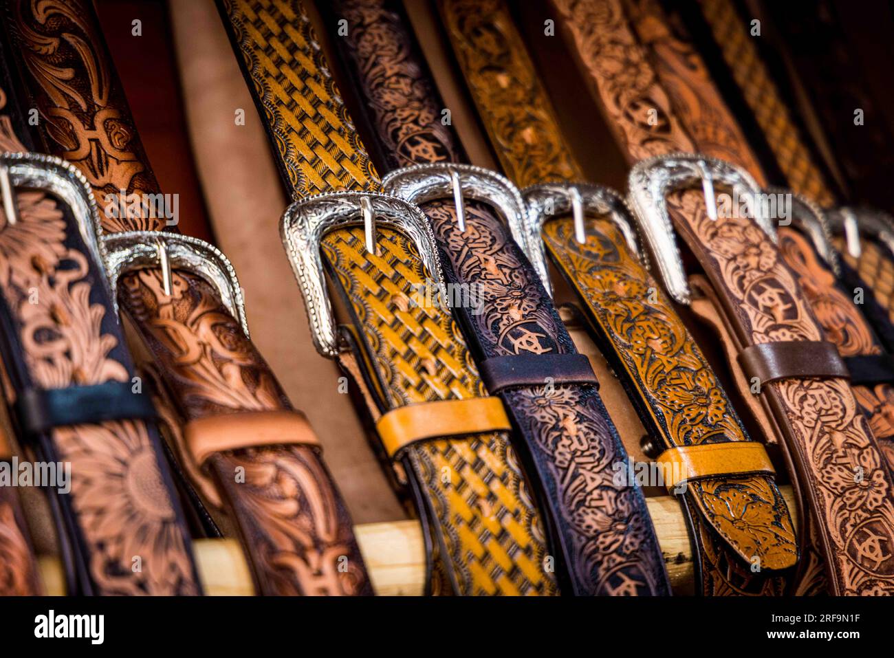 Cowboy boots and leather belts in a business showcase in the center of ...