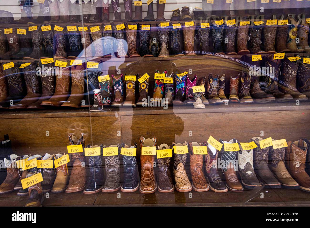 Cowboy boots and leather belts in a business showcase in the center of ...